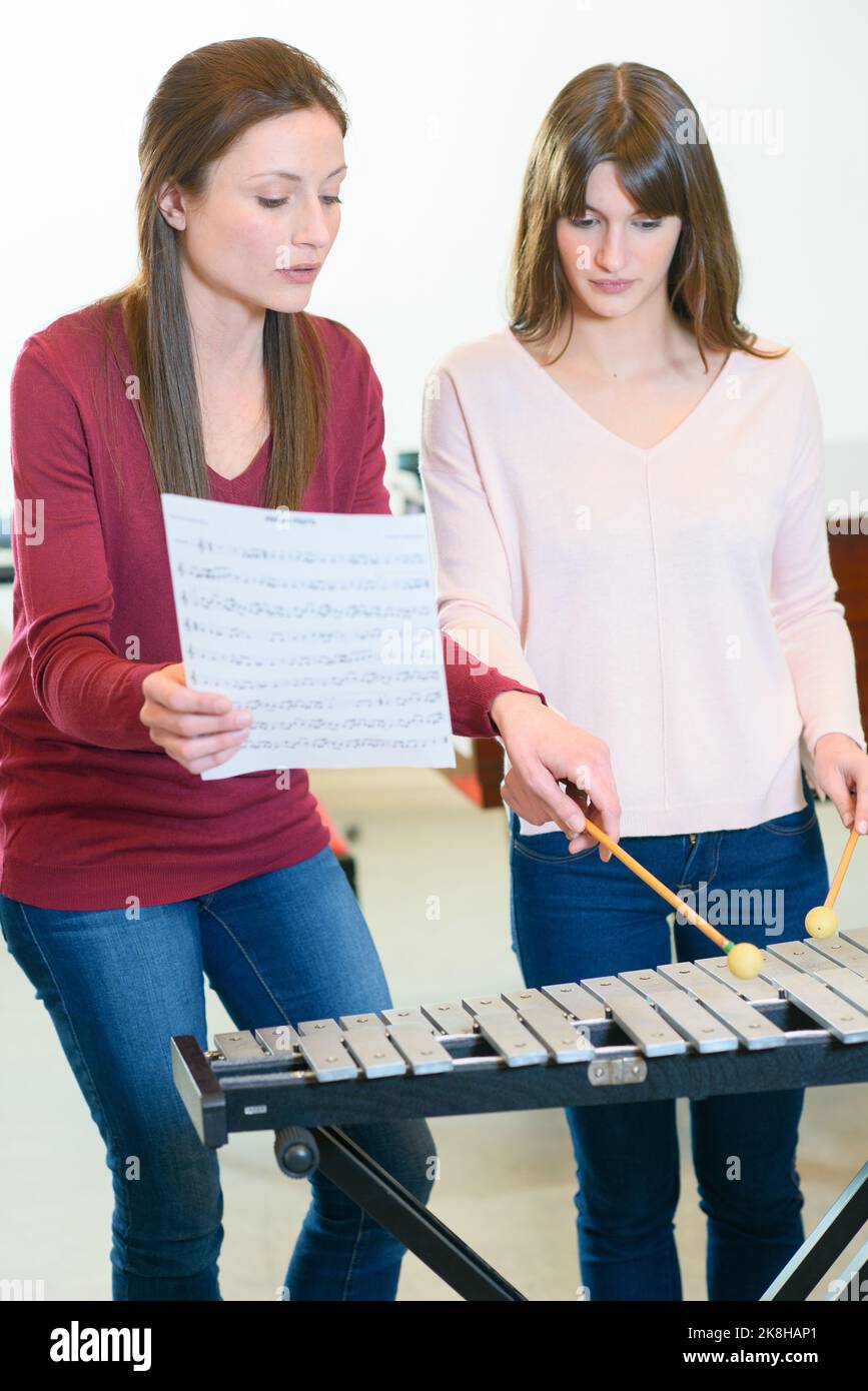 a woman learning percussion instrument Stock Photo - Alamy