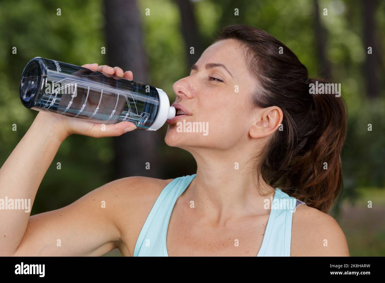 woman doing exercise drinking water Stock Photo - Alamy