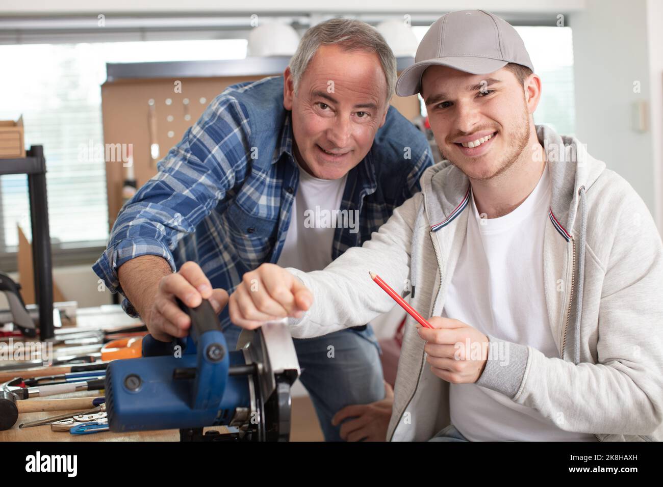 portrait of senior tradesman with junior apprentice Stock Photo - Alamy