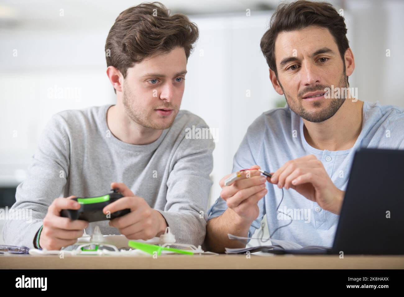 men soldering electrical components on a drone Stock Photo - Alamy