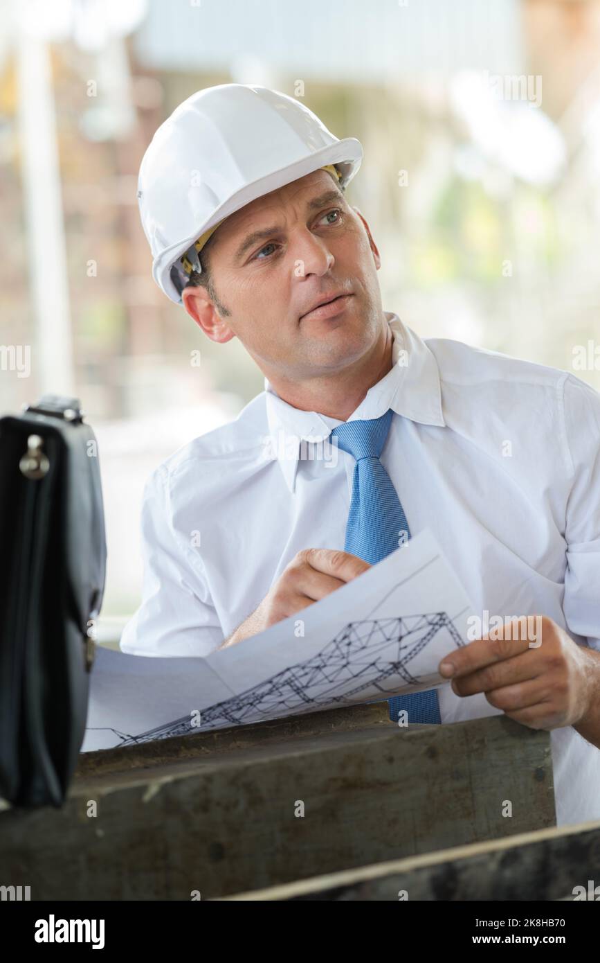 engineer man looking at drawings Stock Photo - Alamy