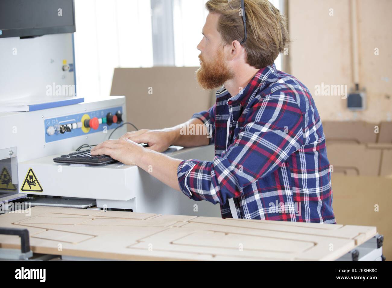 operator cutting wood using special machine Stock Photo - Alamy