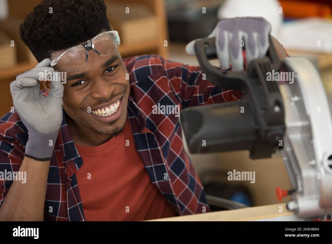 happy male carpenter with circular saw in woodworking Stock Photo - Alamy