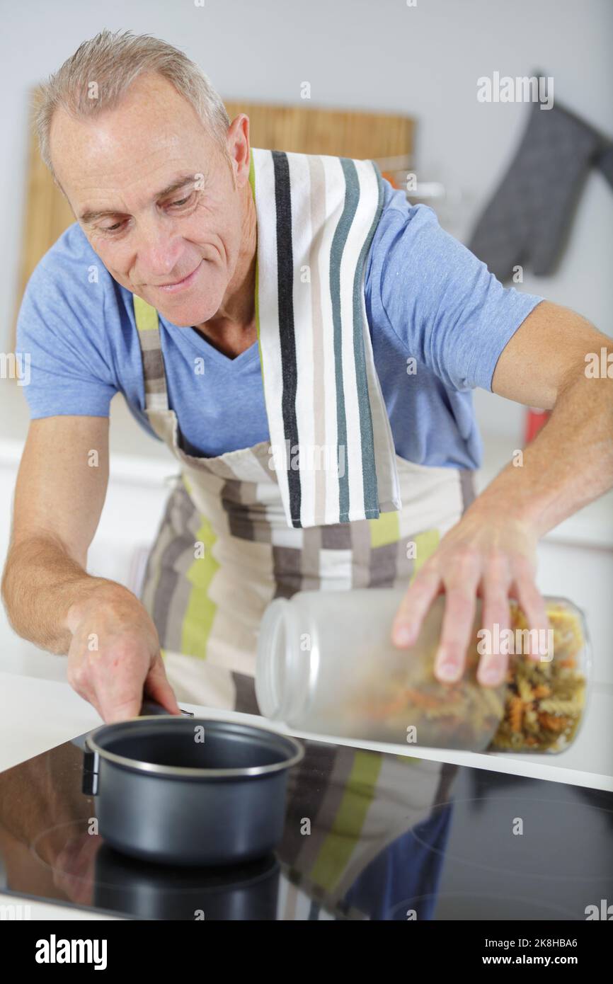 an elderly man cooking pasta Stock Photo - Alamy