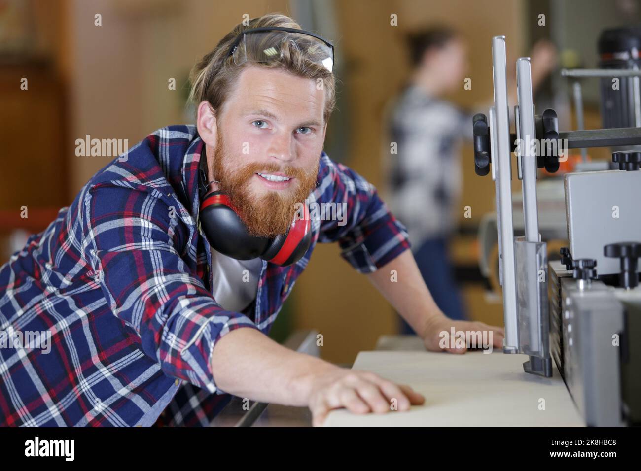 man cutting wood with machine Stock Photo - Alamy