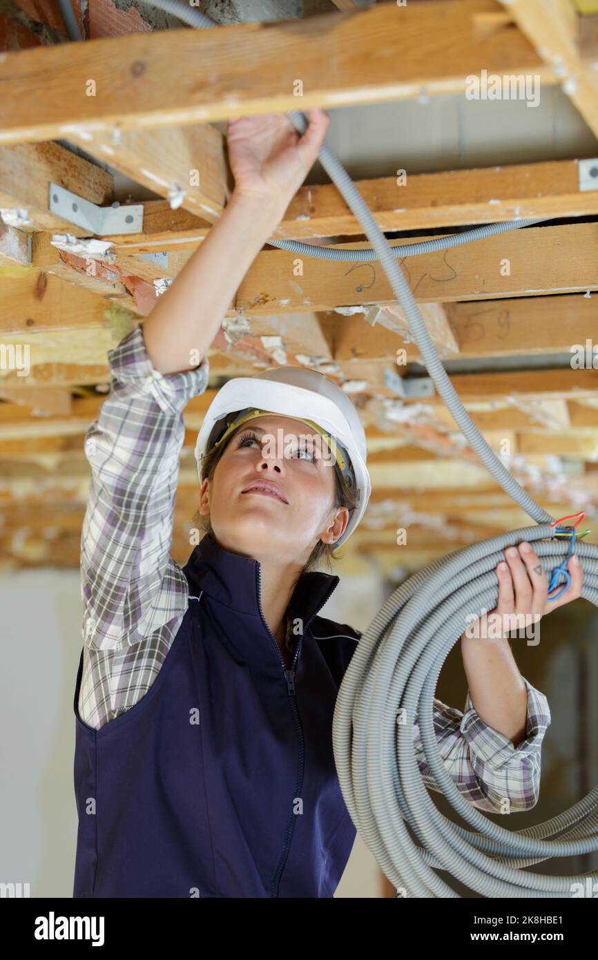 portrait of a woman builder holding cables Stock Photo - Alamy