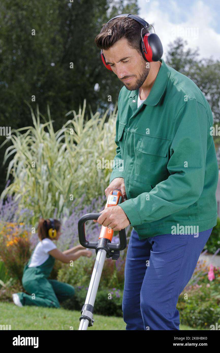 a man cutting the grass Stock Photo - Alamy