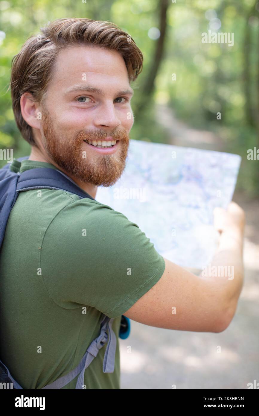 Handsome hiker holding map mountain hi-res stock photography and images ...