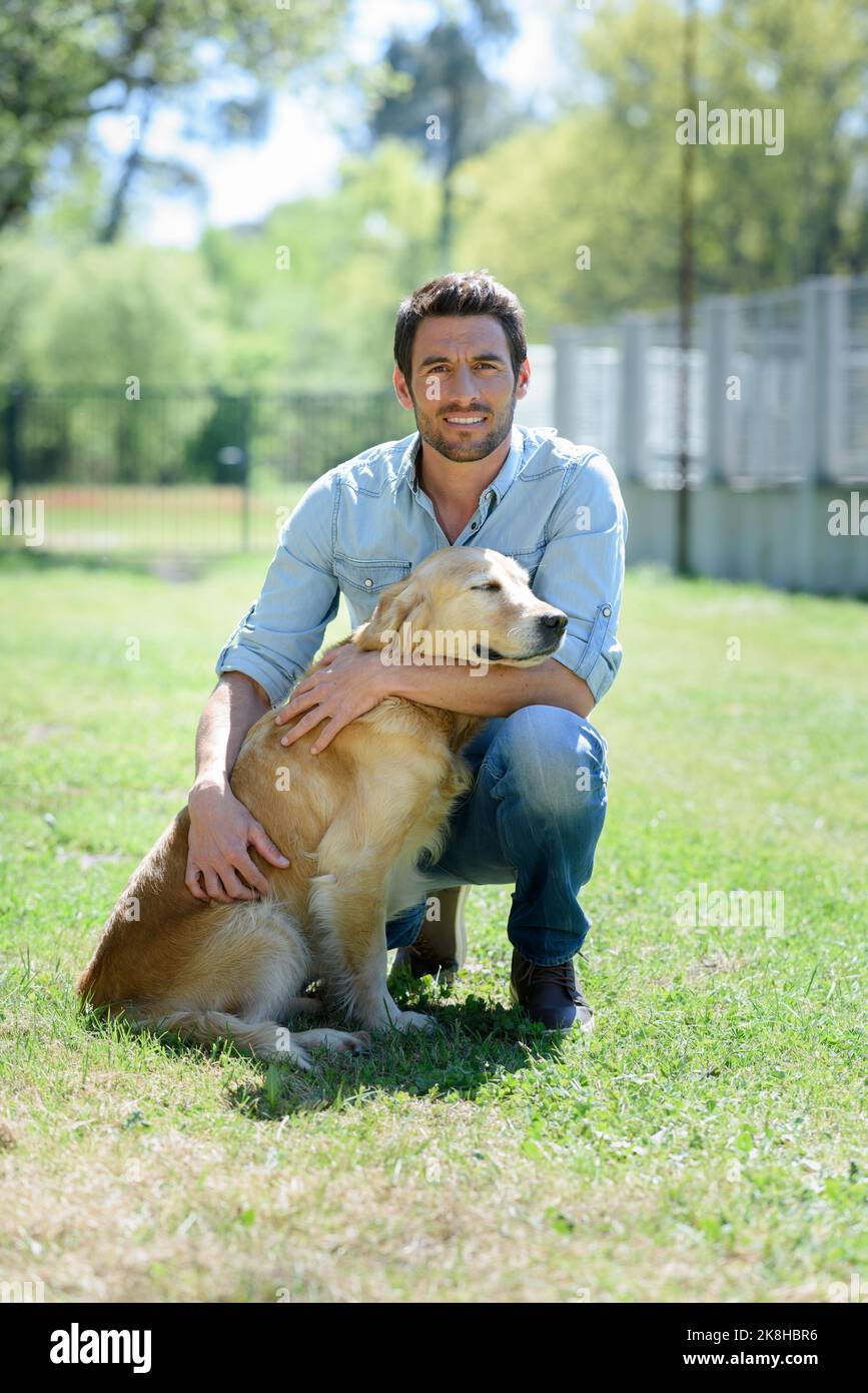 a man hugging a dog Stock Photo - Alamy