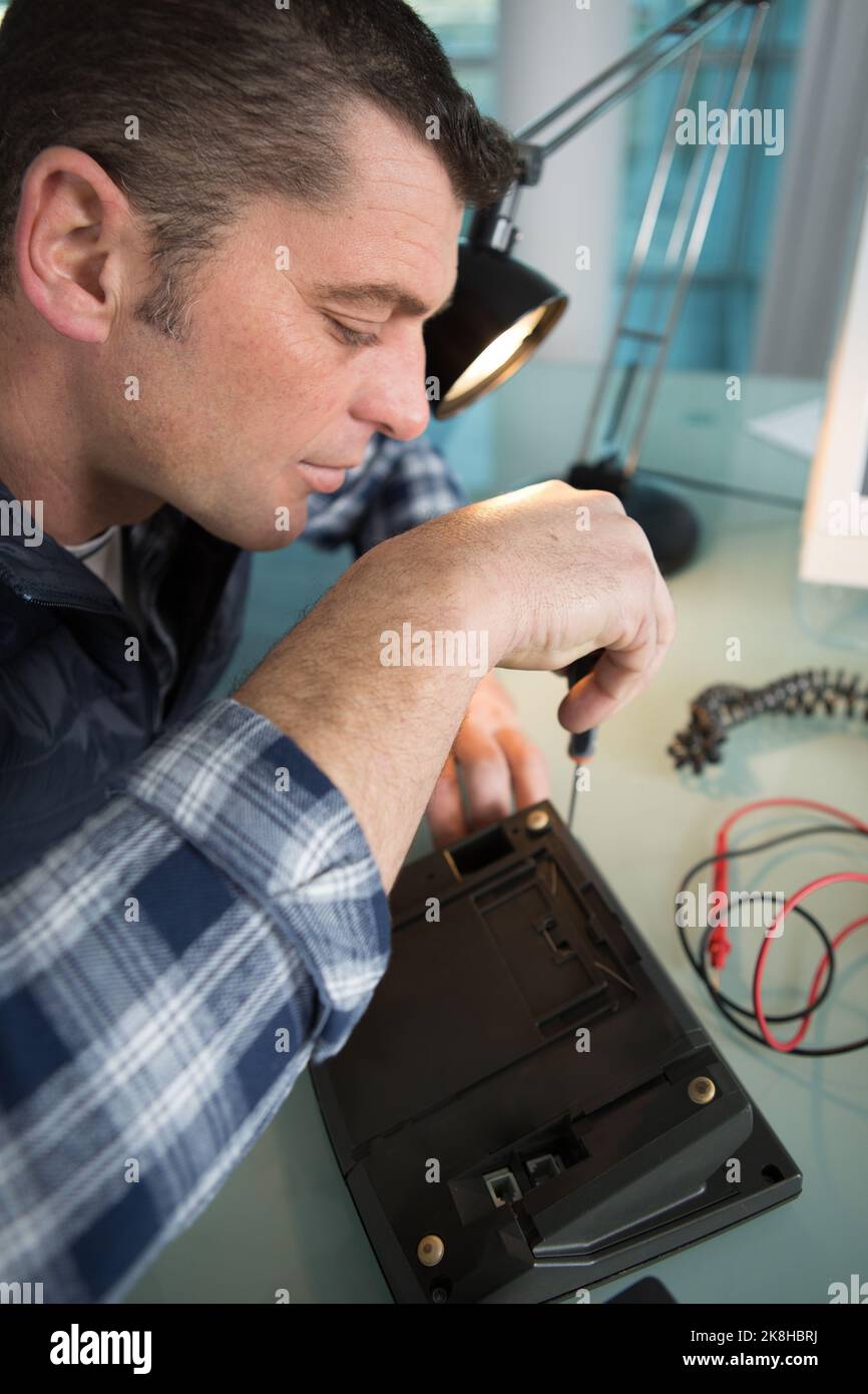man is fixing a telephone Stock Photo - Alamy