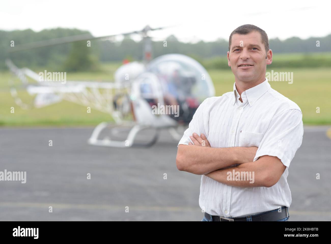 pilot standing near helicopter on a landing point Stock Photo - Alamy