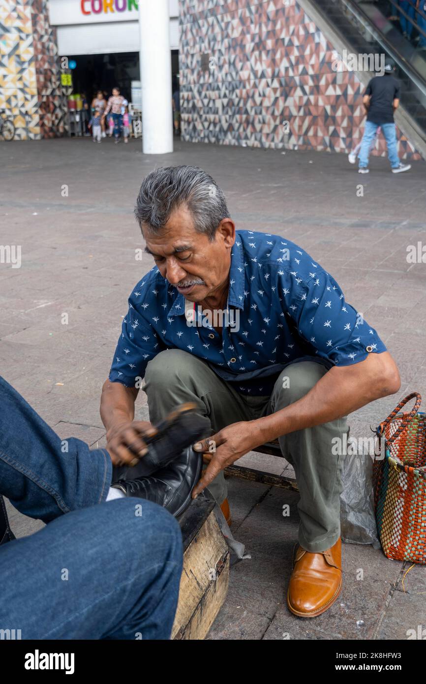 shoes in a wash basin with soapy water. cleaning the shoes at street ...