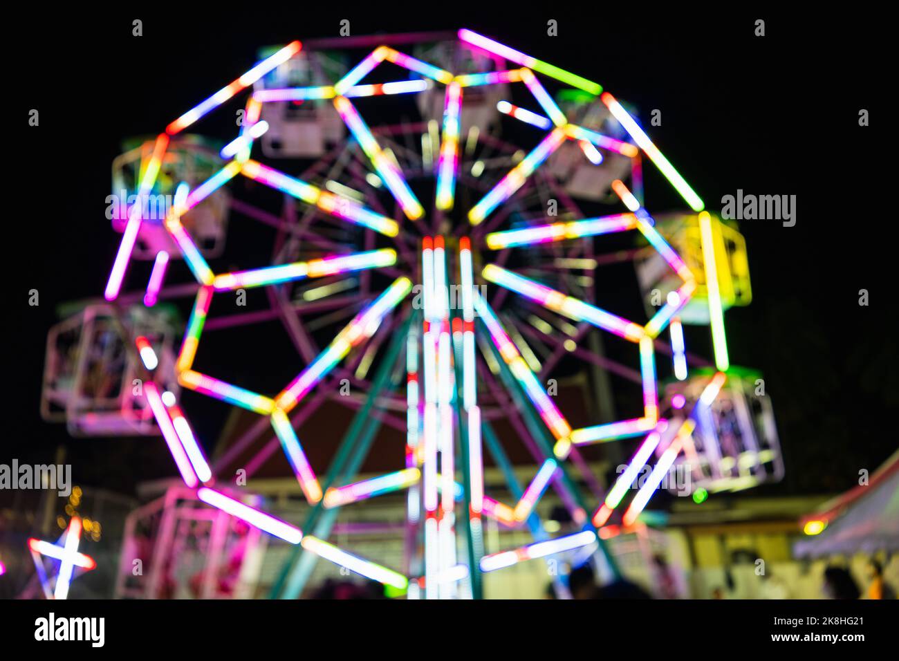 Blurry rollercoaster in bokeh, Ferris wheel at night of colorful with ...