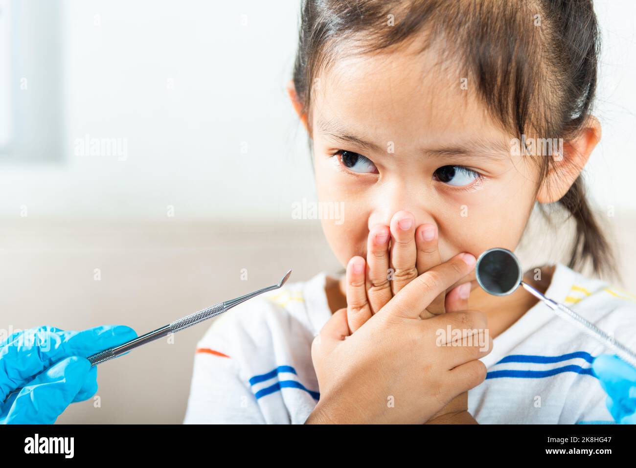 Dental kid examination. Doctor examines oral cavity of child uses mouth ...