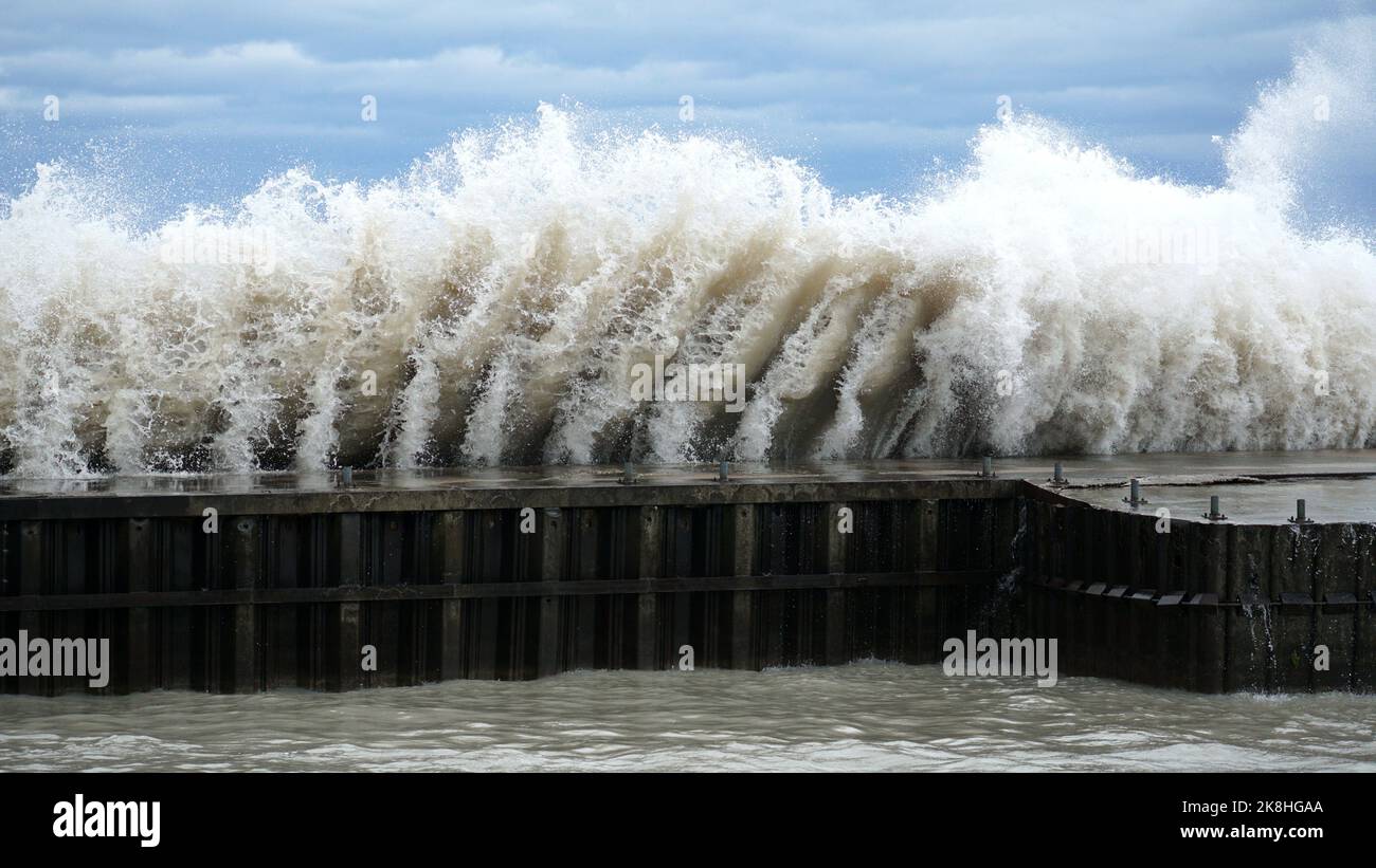 A wave crashes into a break wall along Lake Michigan’s shoreline at ...