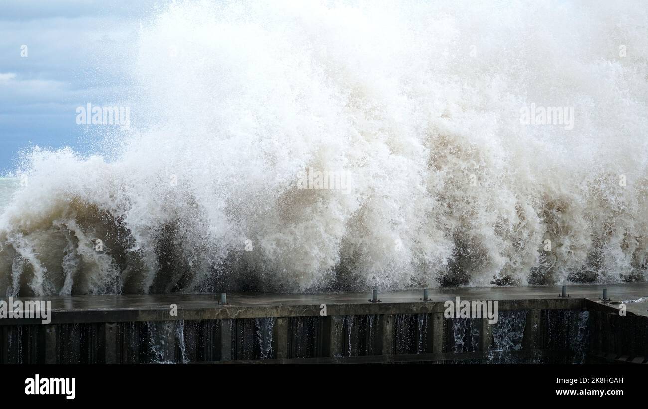 A wave crashes into a break wall along Lake Michigan’s shoreline at ...