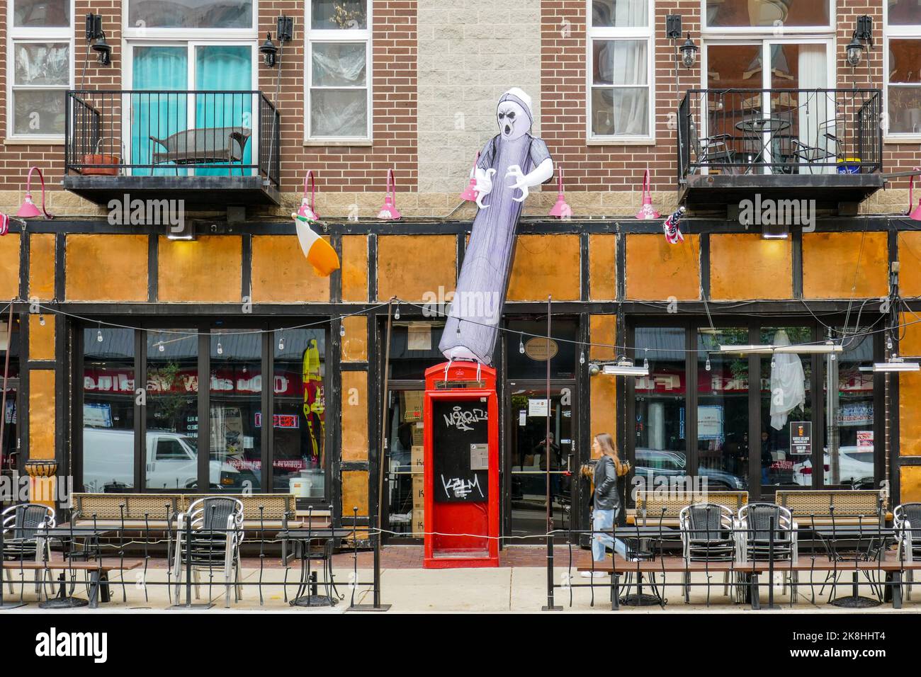 A giant ghoul decoration fastened to a British style phone booth ...