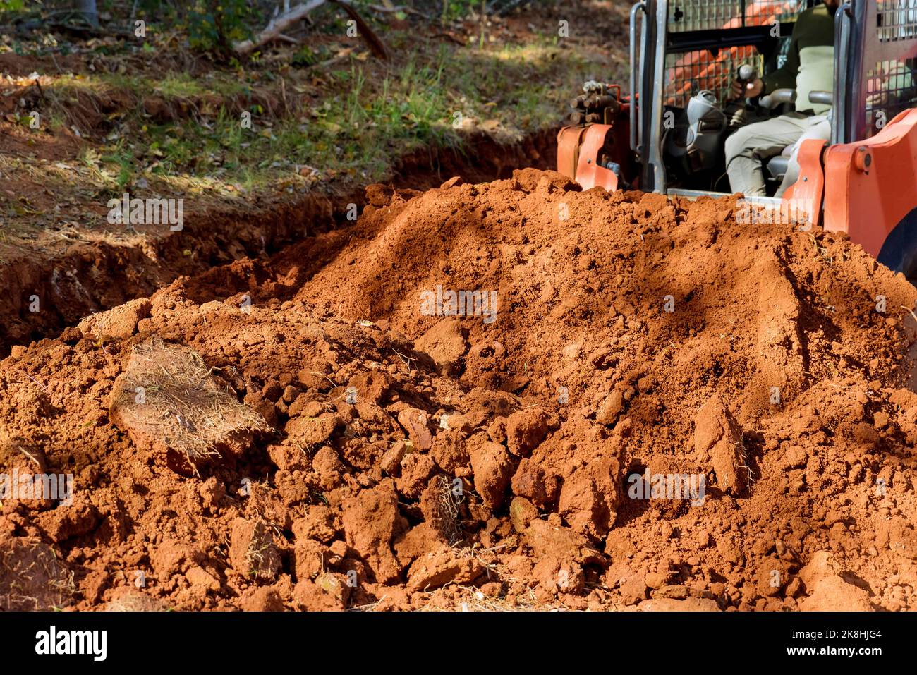 Small tractor used to move soil in construction site landscaped area ...