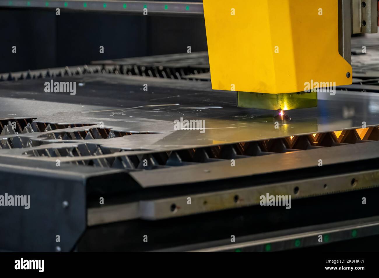 laser cutting machine, cutting wood sheets, while a man records the ...