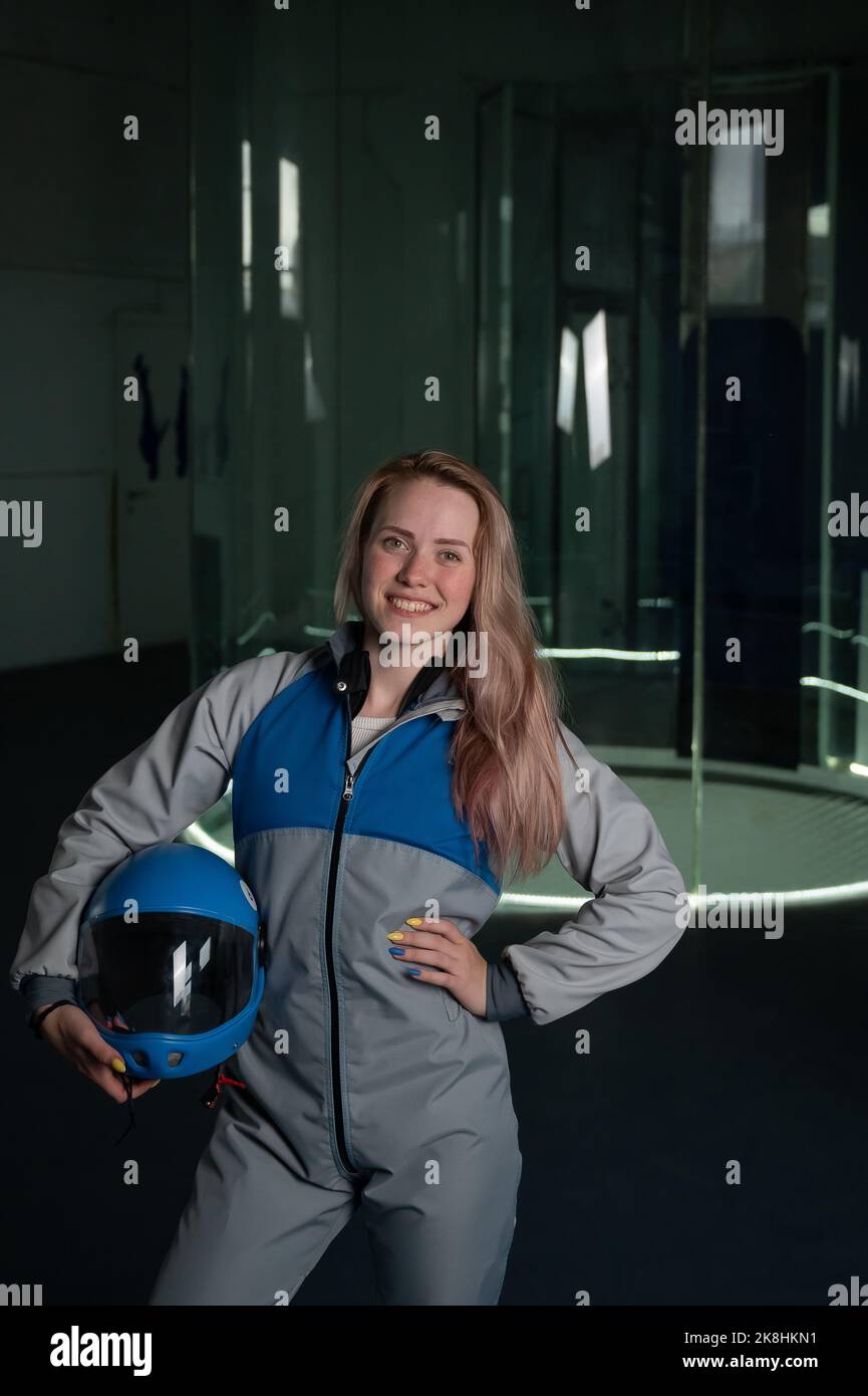 Caucasian woman puts on a helmet before flying in a wind tunnel. Free ...