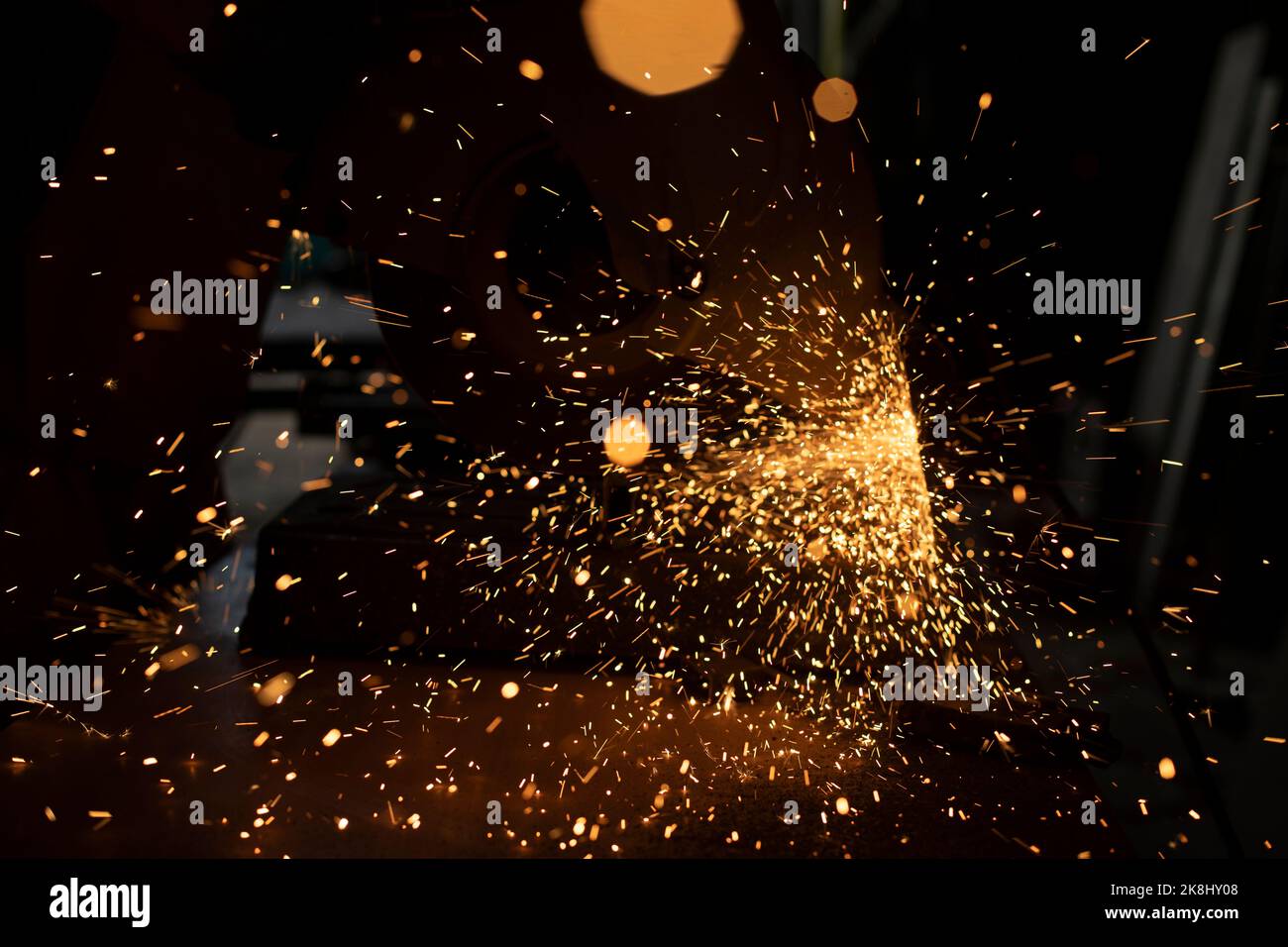 Sparks from grinder. Metal cutting. Bright lights in dark. Industrial ...