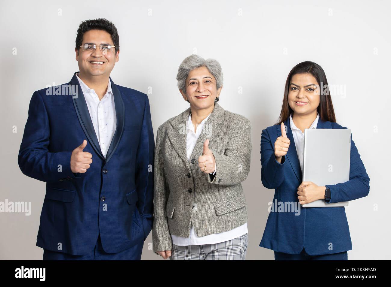 Group of positive indian business partners wearing suit standing thumbs ...