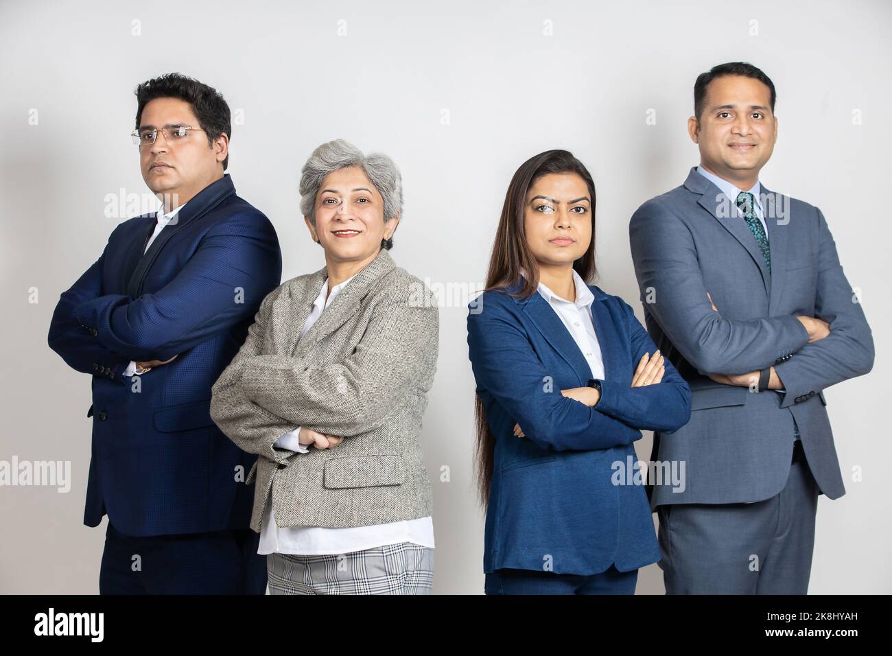 Group of positive indian business partners wearing suit standing cross ...