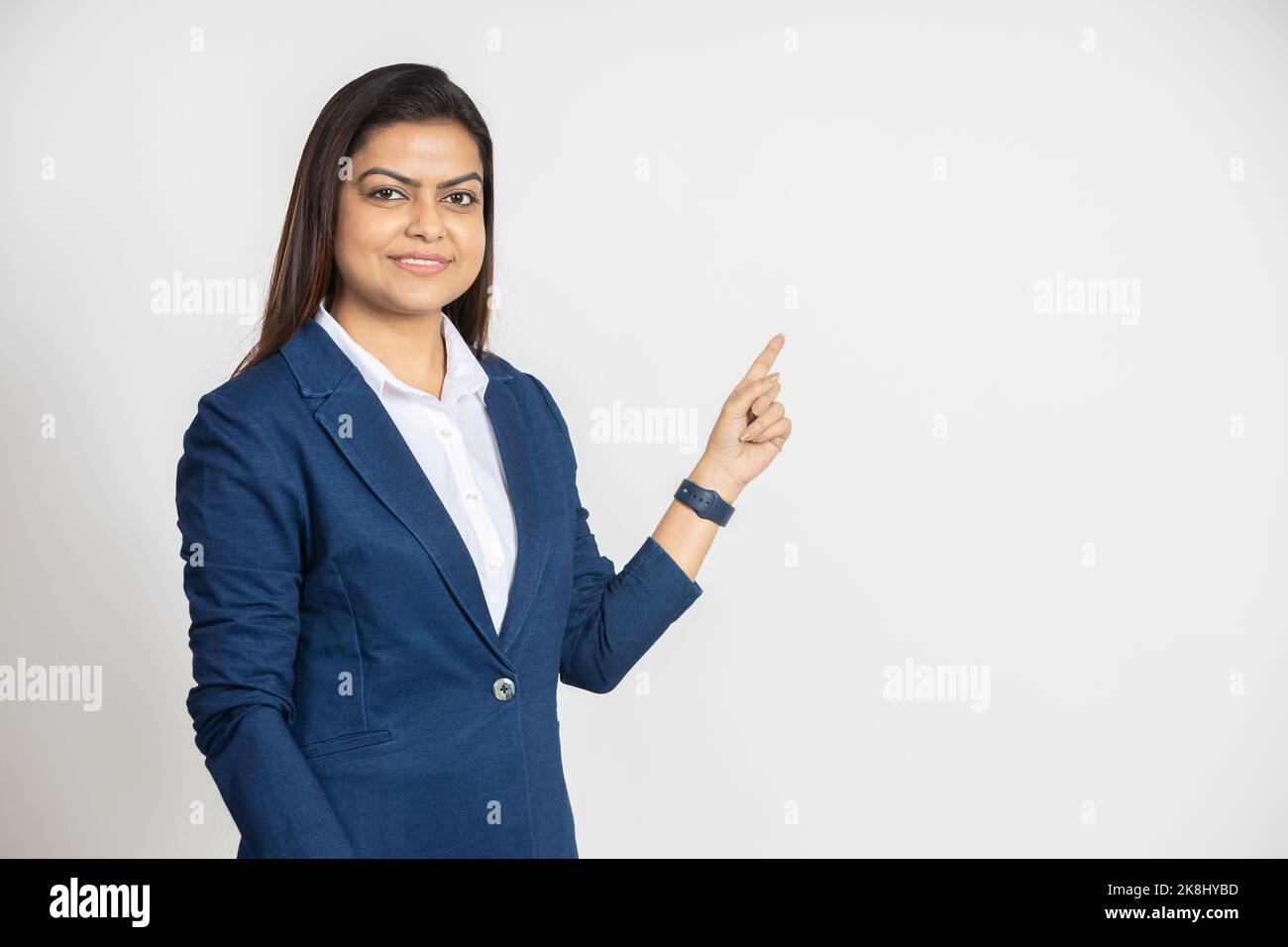 Portrait of happy young Indian businesswoman or corporate girl shows ...