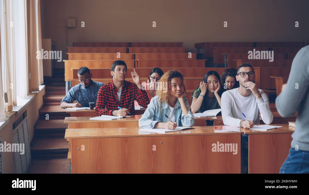 Multi-ethnic group of students is answering teacher's questions, smart ... Multi-ethnic group of students is answering teacher's questions, smart ...