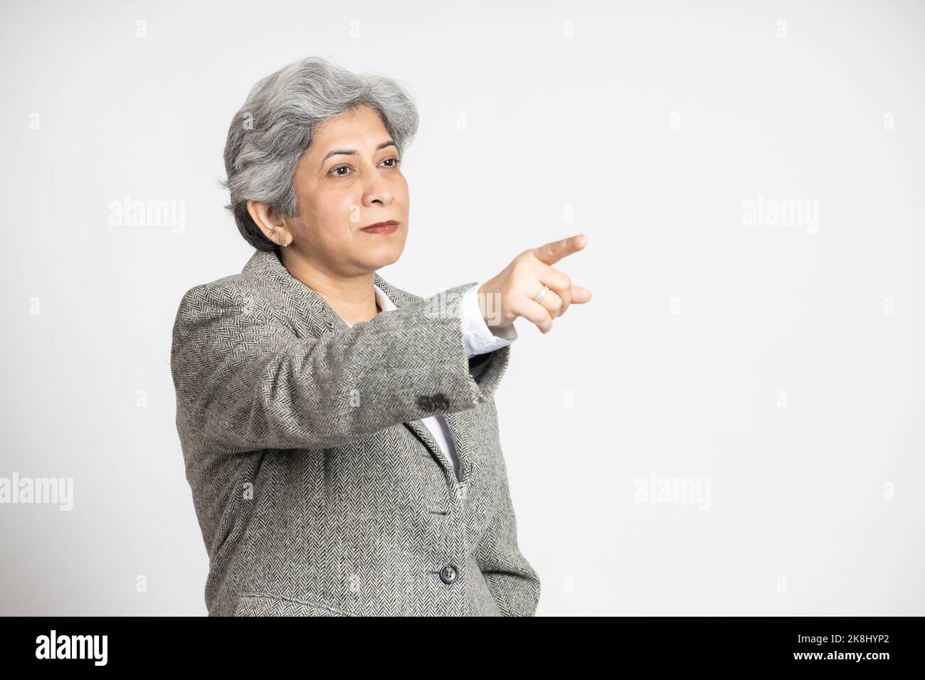 Mature senior indian businesswoman leader point finger at distance ...