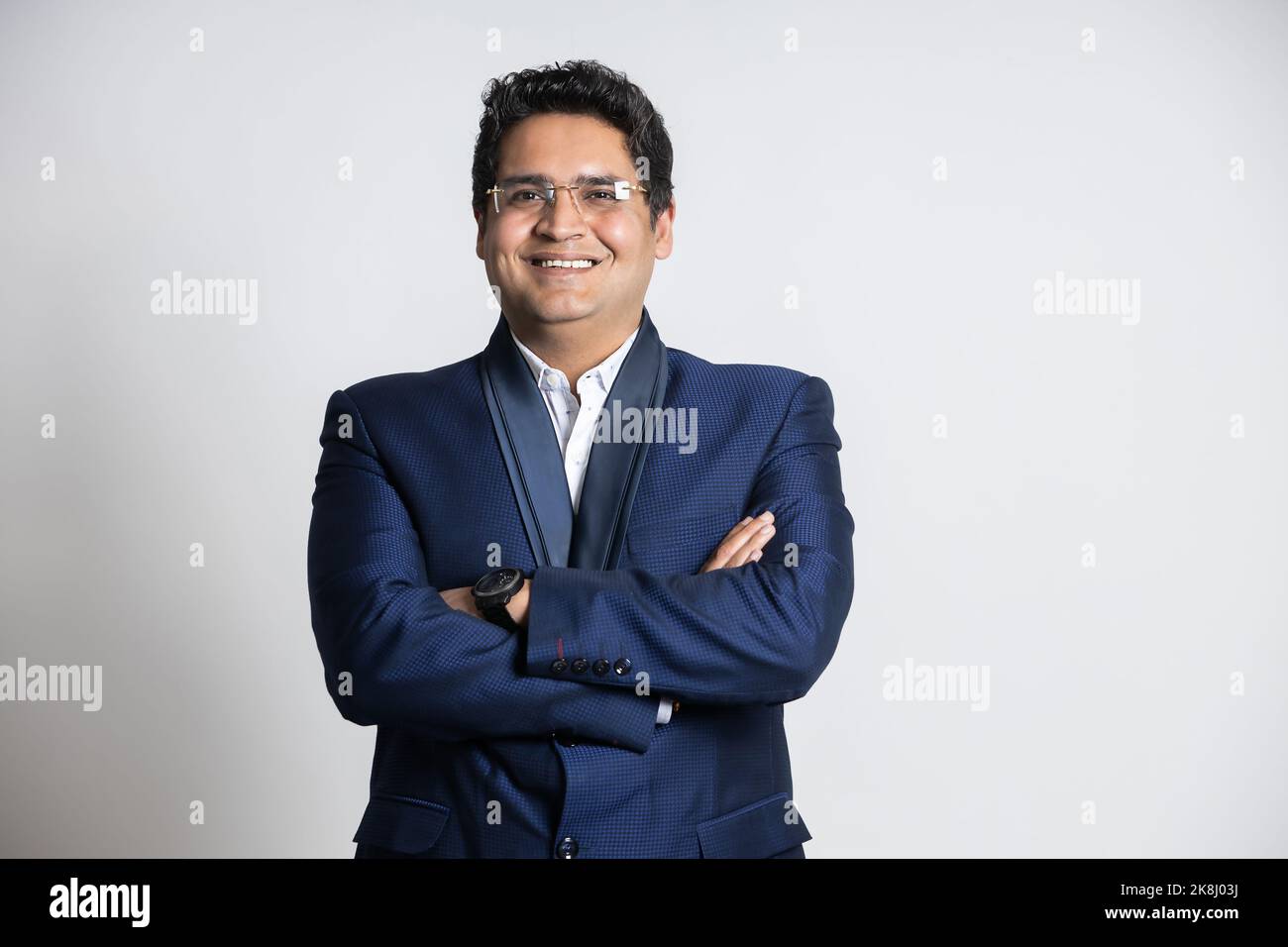 Portrait of a confident young indian business man in a suit standing ...