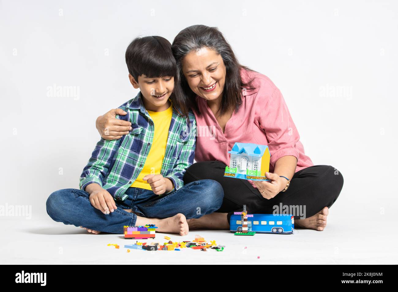 Happy indian grandmother and grandson playing with colorful Toys ...