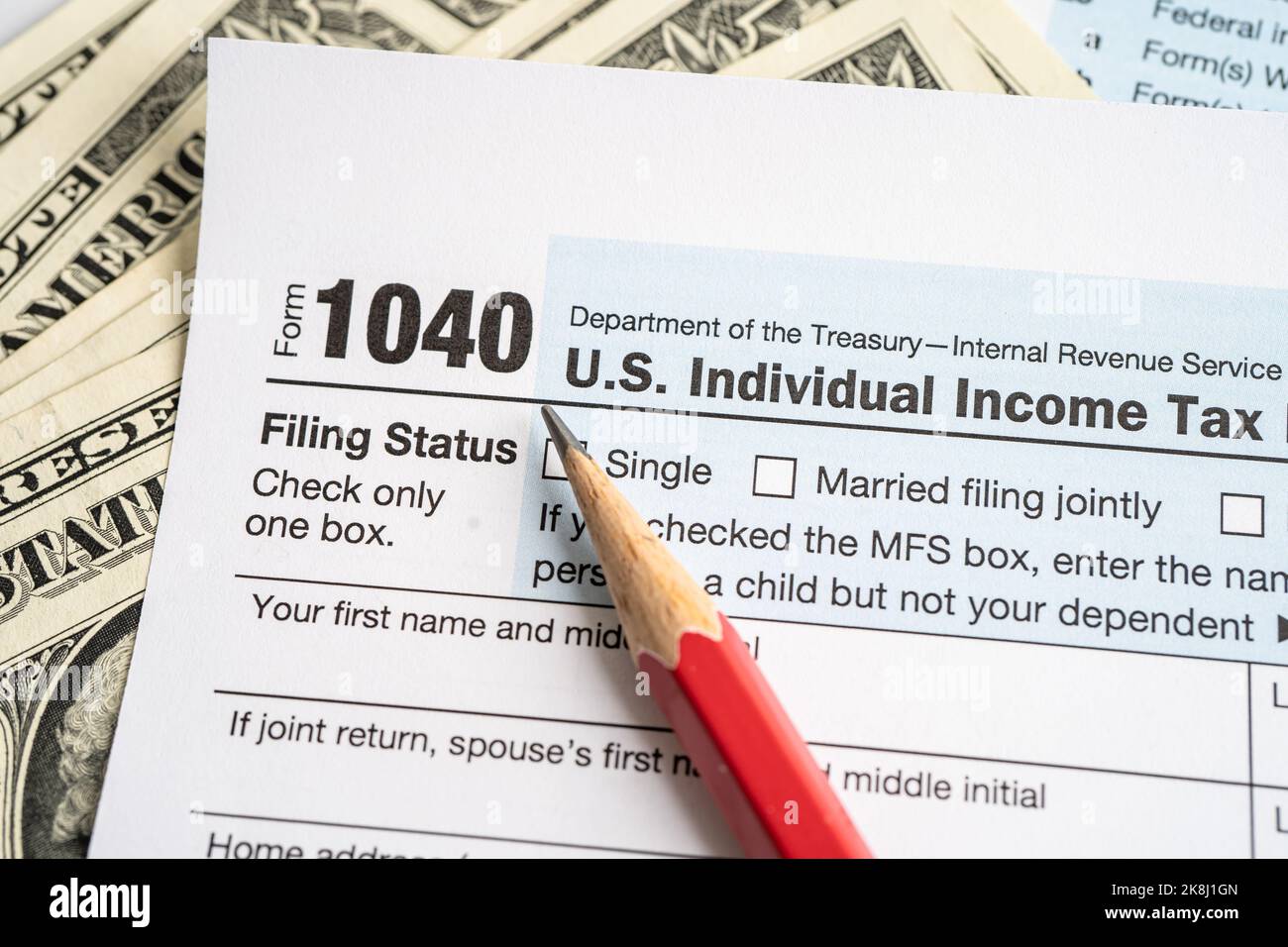 Tax Return form 1040 with USA America flag and dollar banknote, U.S ...