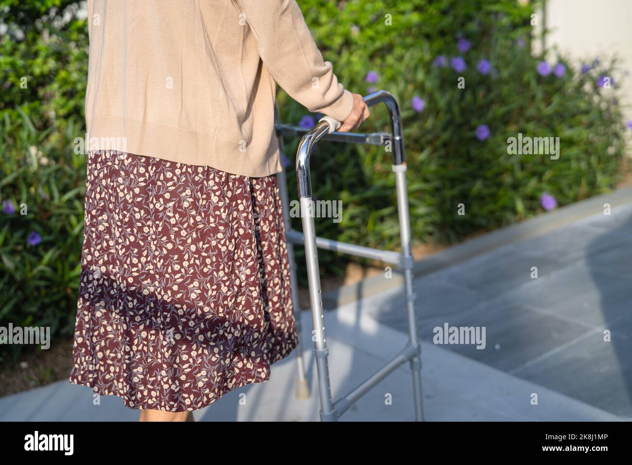 Asian senior or elderly old lady woman patient walk with walker in park ...