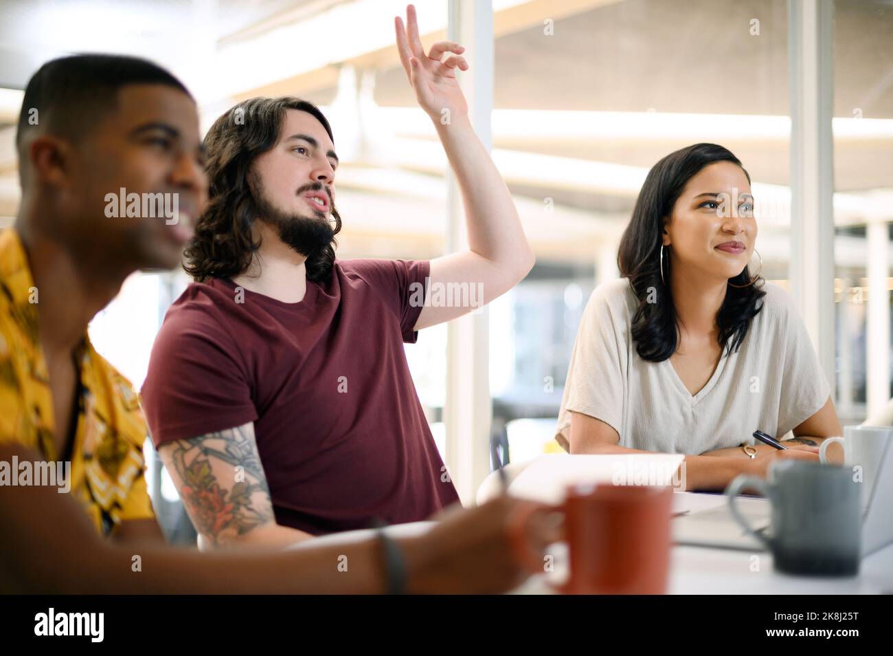 I have a question before you continue...a young businessman raising his ...