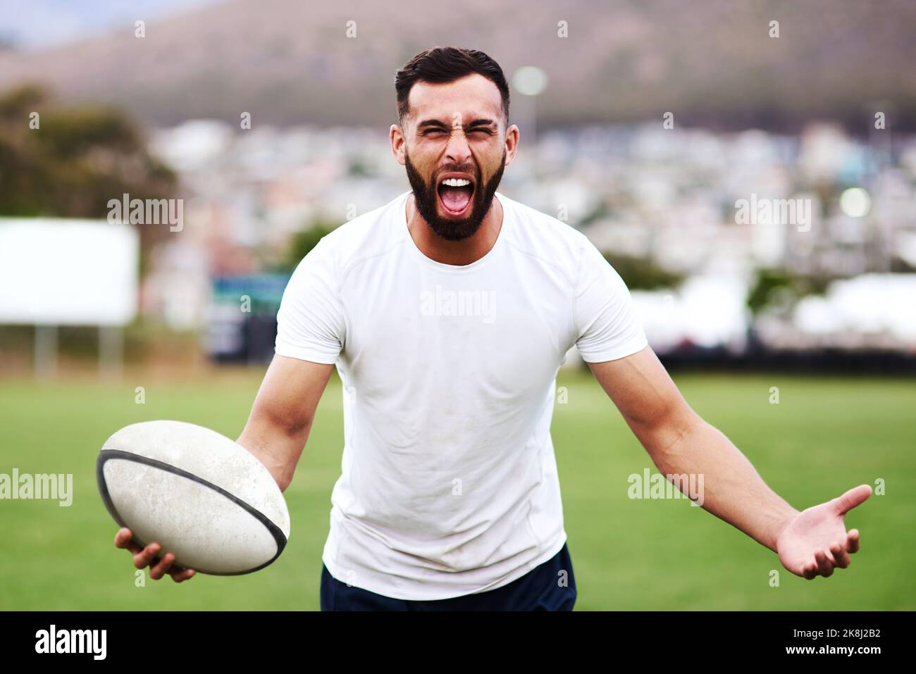 Rugby players dont talk, they roar. Portrait of an enthusiastic young ...
