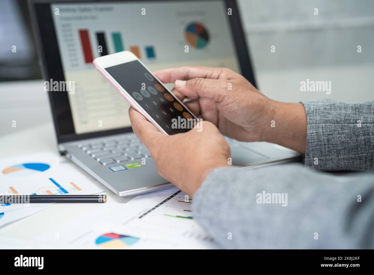 Asian accountant working and analyzing financial reports project ...