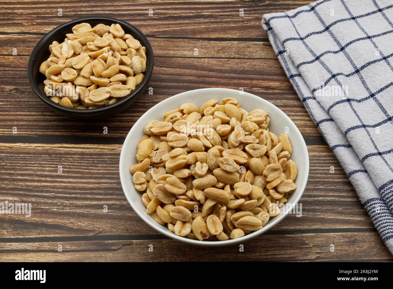 Pealed Peanuts in a bowl isolated on wooden background Stock Photo - Alamy