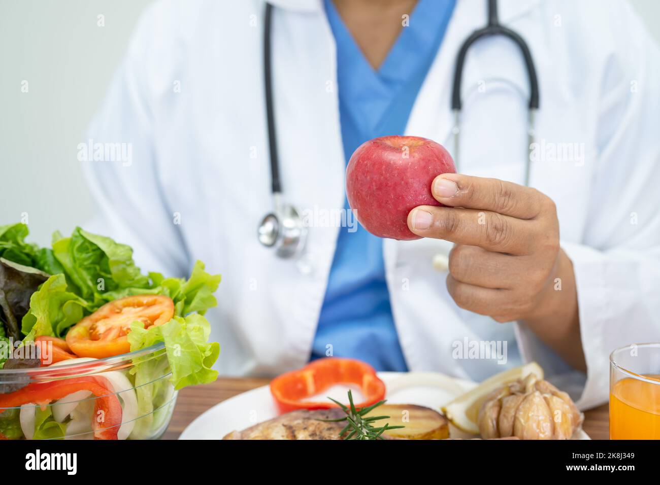Nutritionist doctor with various healthy fresh vegetables for patient ...