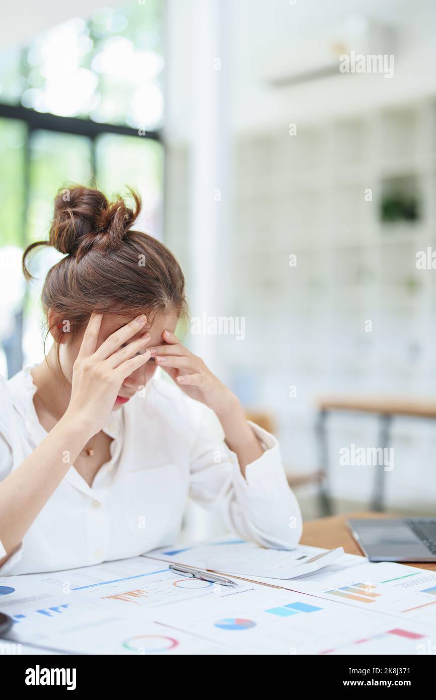 portrait of a women employee shows an anxious and stressed face from ...