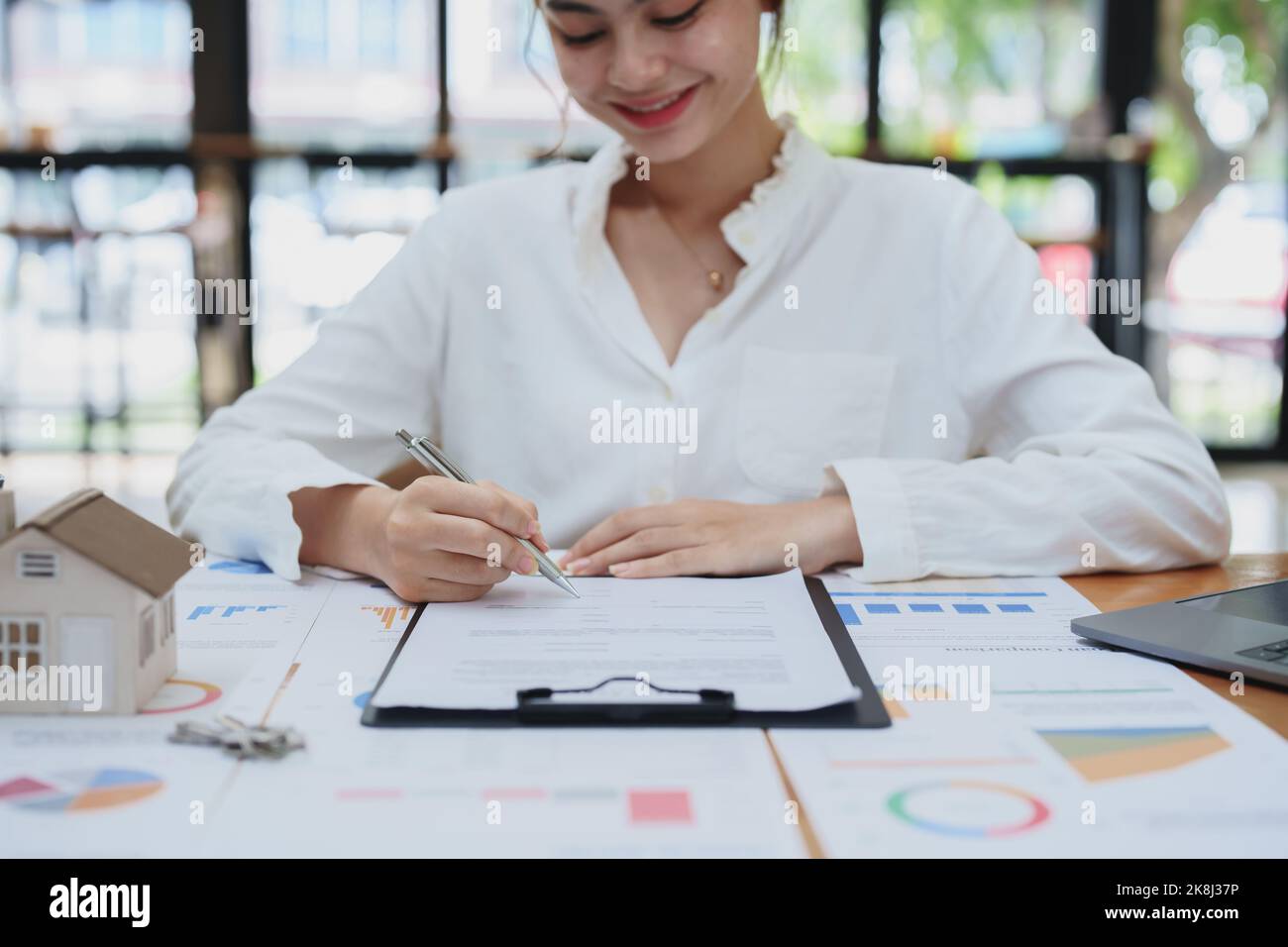 Portrait of a beautiful bank young woman sign credit department of ...
