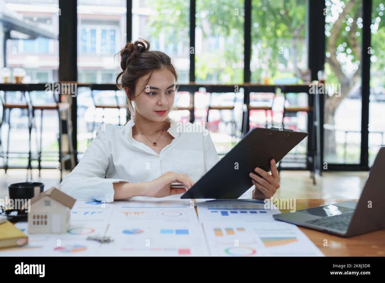 Portrait of a beautiful bank young woman sign credit department of ...