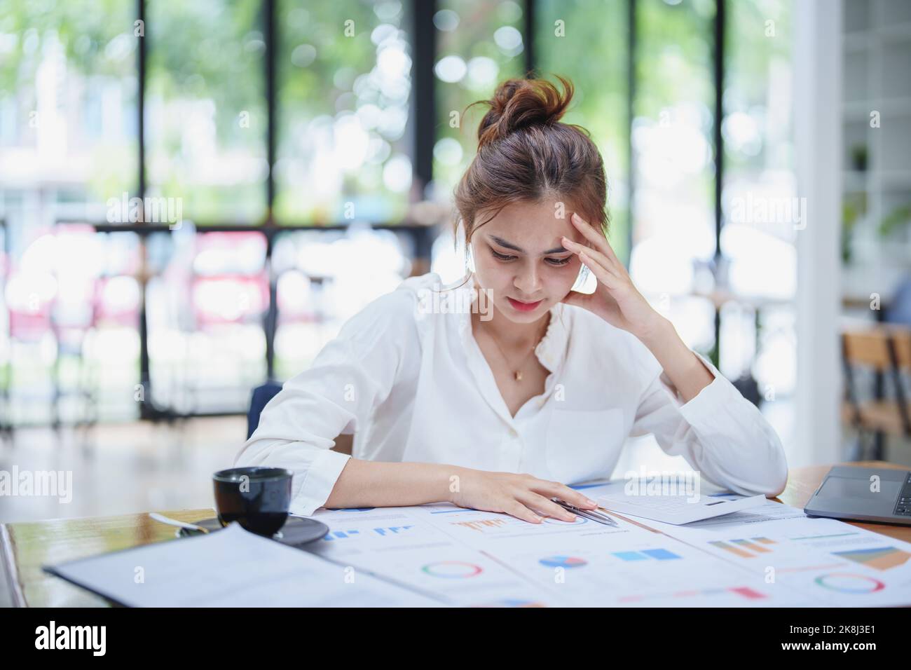 portrait of a women employee shows an anxious and stressed face from ...