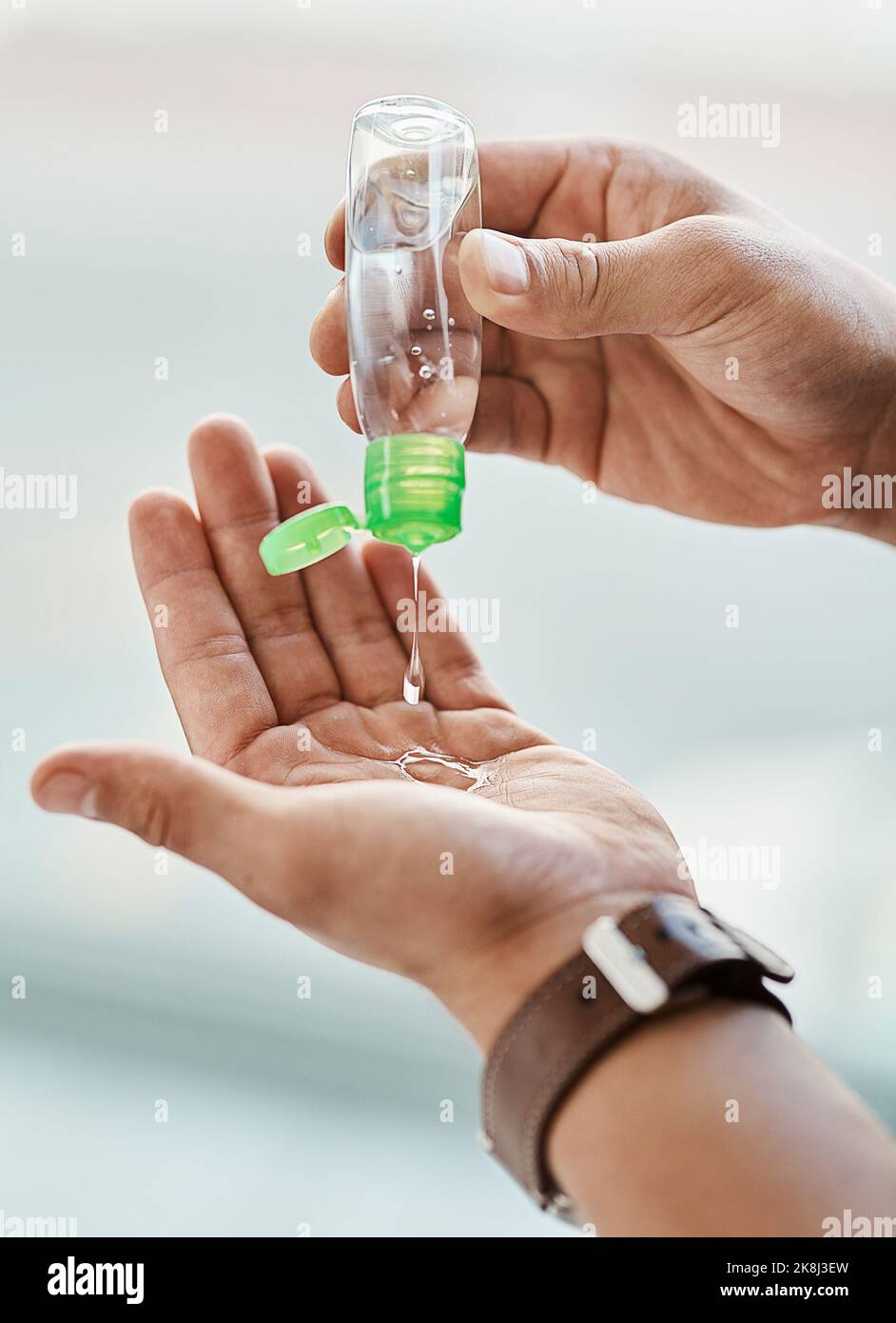 Whatever you do, keep your hands clean. a man using hand sanitiser to ...