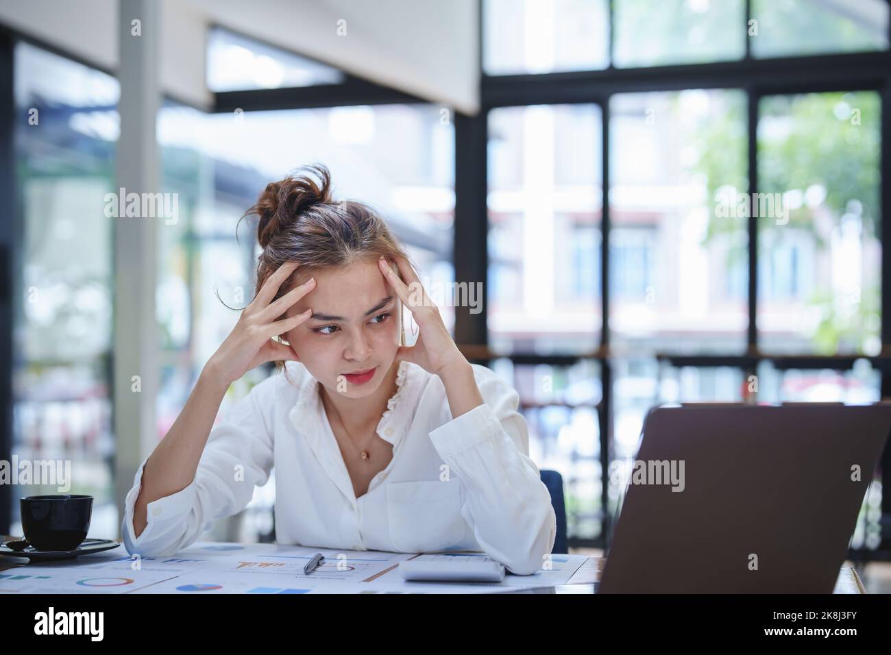 portrait of a women employee shows an anxious and stressed face from ...