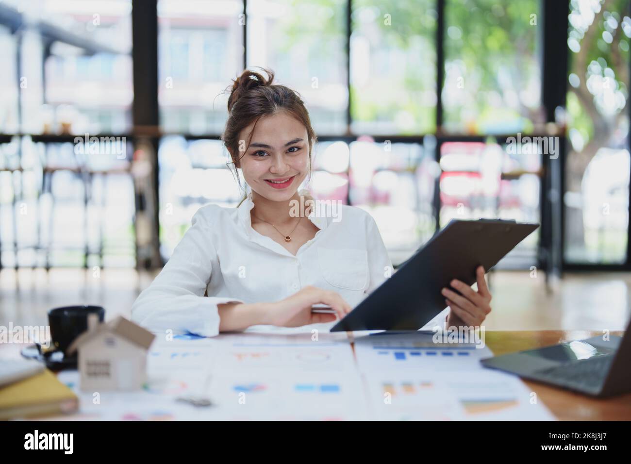 Portrait of a beautiful bank young woman sign credit department of ...