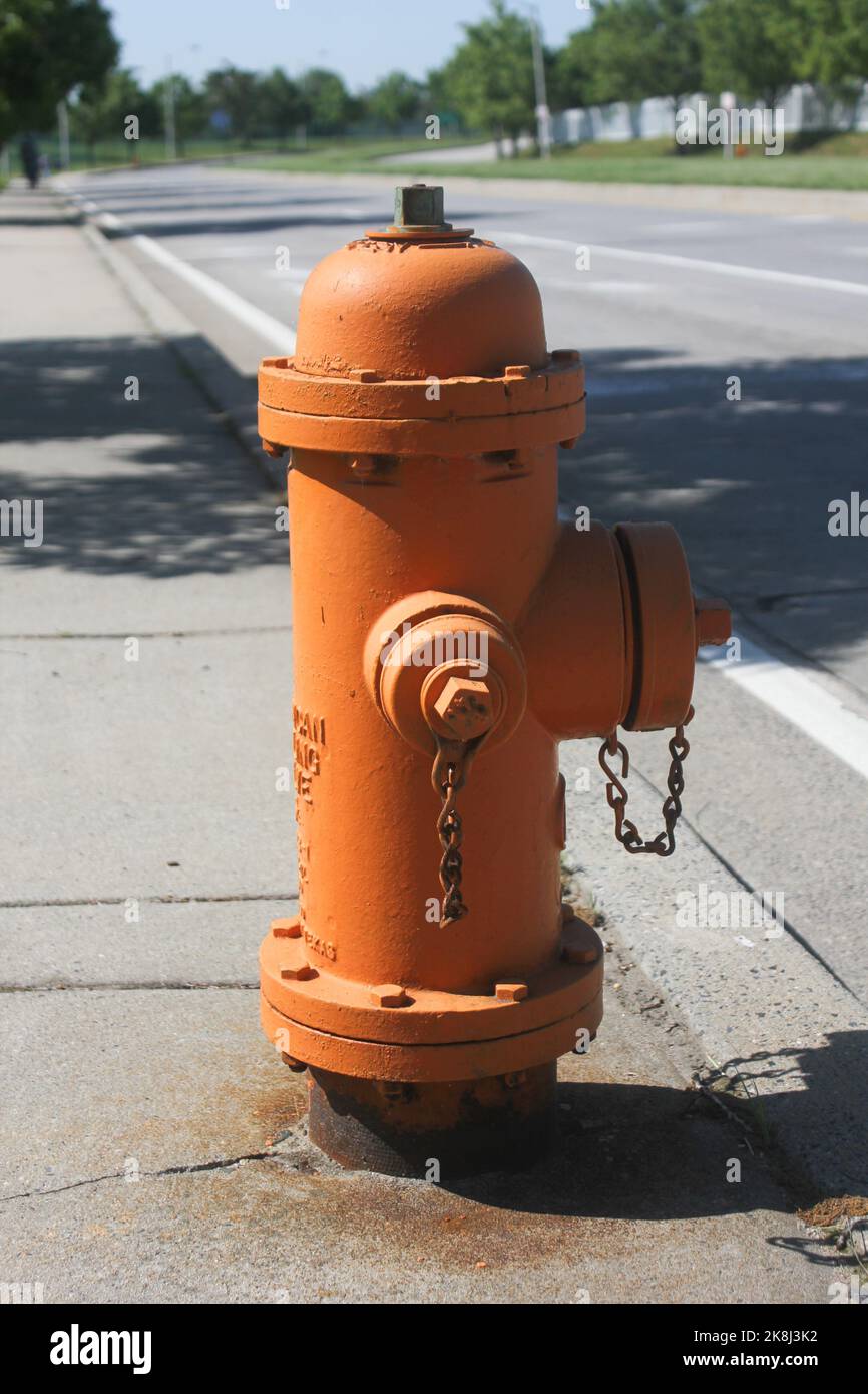 Yellow fire hydrant wide open gushing water onto the street with ...