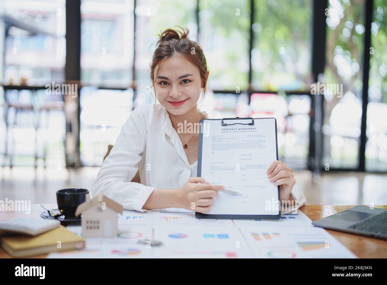 Portrait of a beautiful bank young woman sign credit department of ...