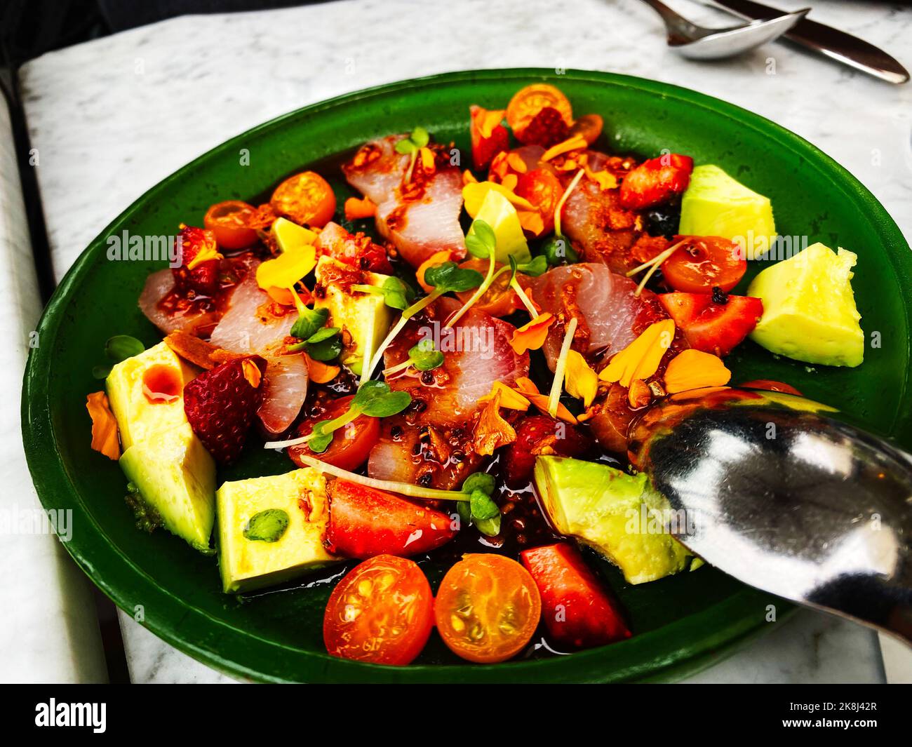 An avocado strawberry salad. Healthy lunch at a fancy rooftop ...