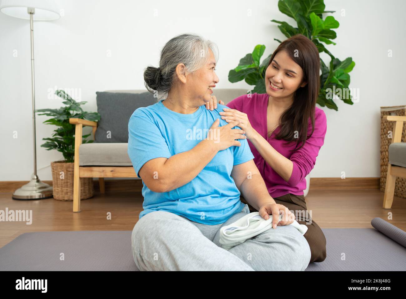 Asian careful caregiver or nurse taking care of the patient in a home ...